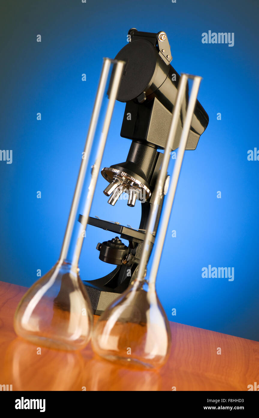 Microscope against blue gradient background Stock Photo - Alamy