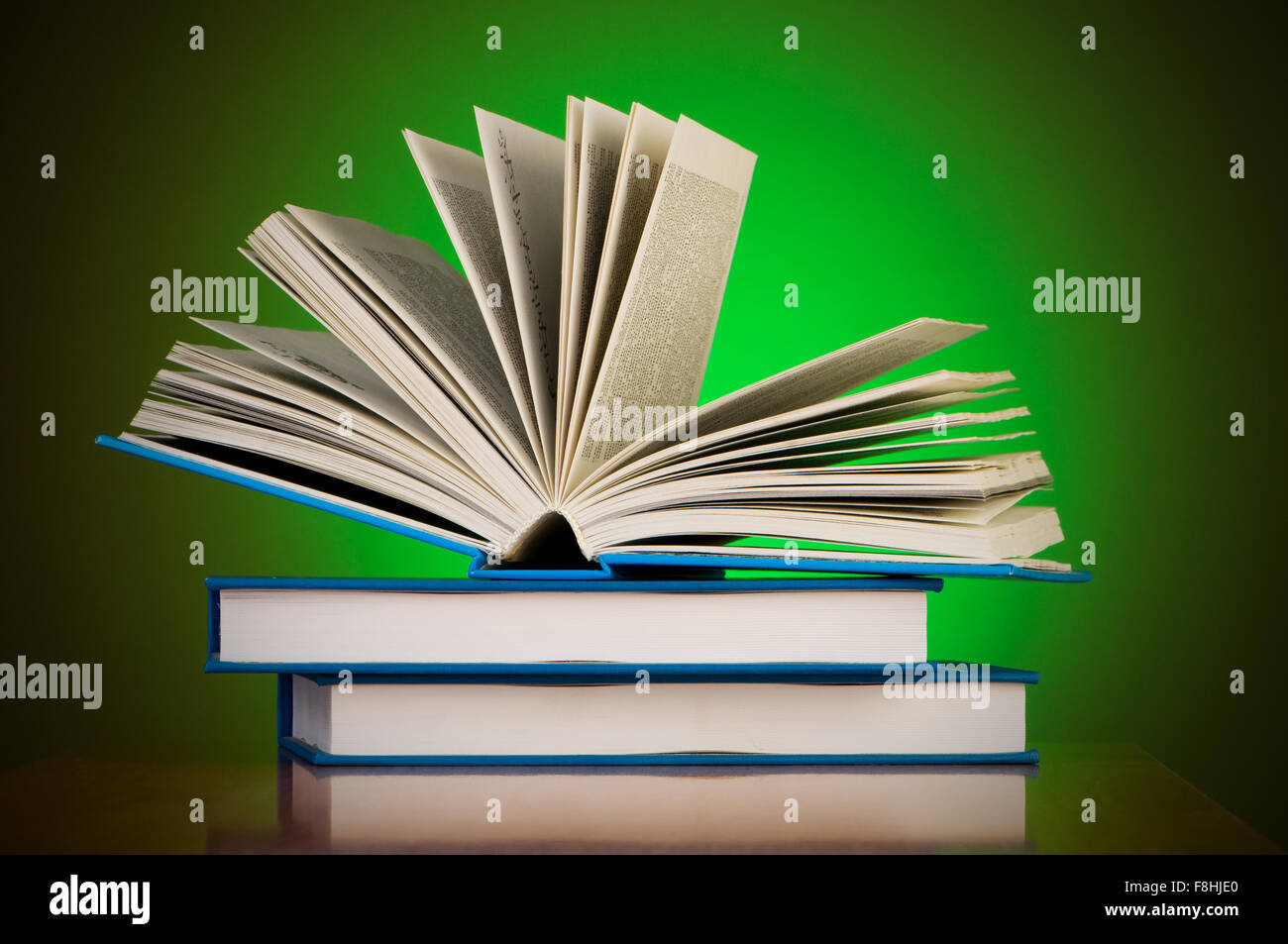 Stack of books against gradient background Stock Photo - Alamy