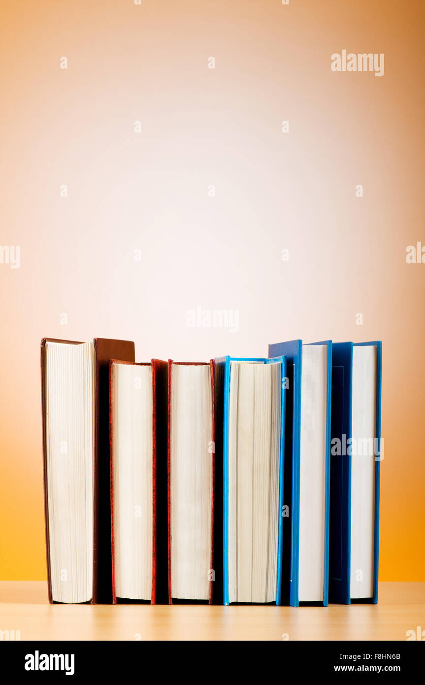 Stack of text books against gradient background Stock Photo - Alamy