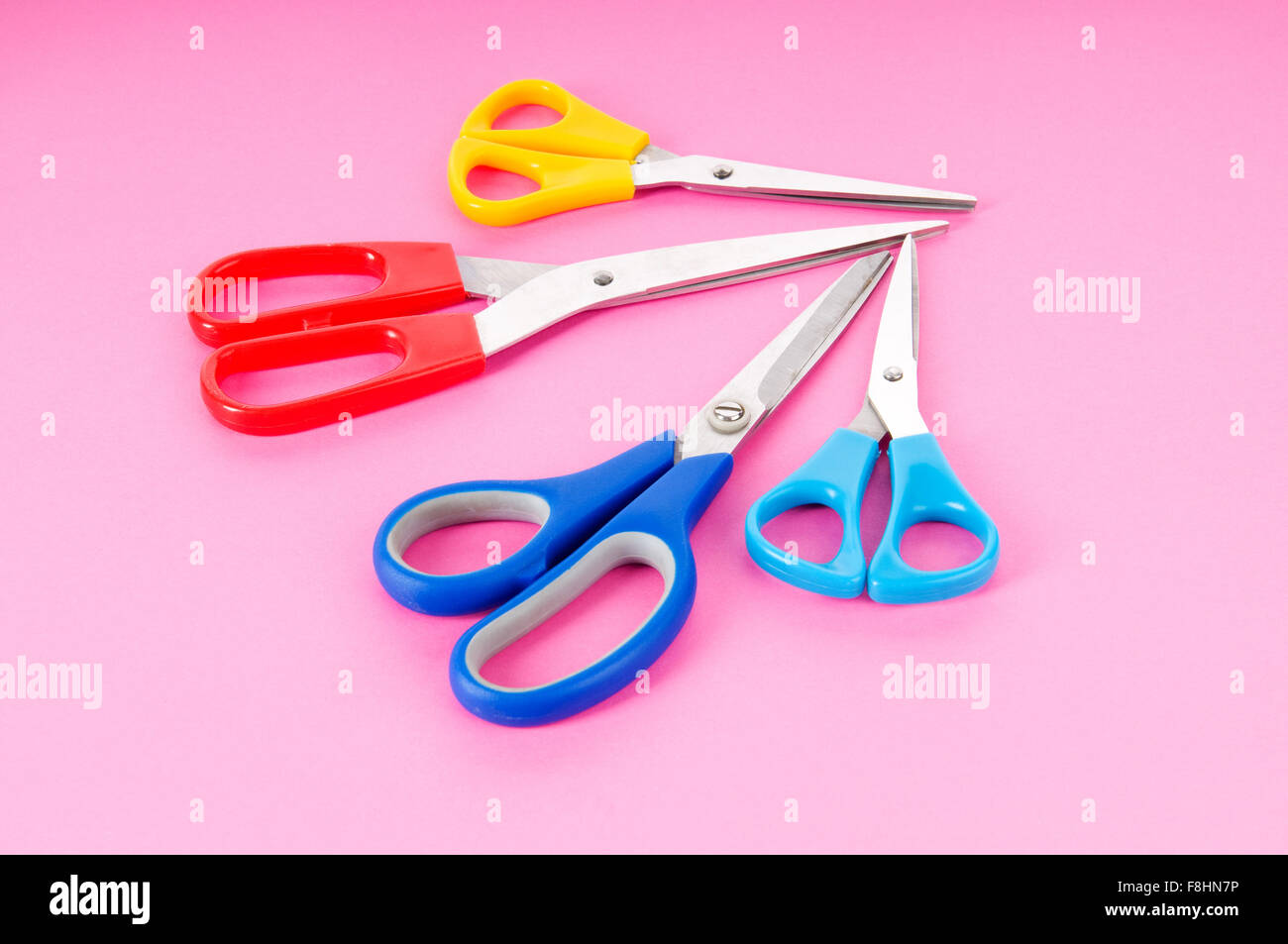 Colorful scissors on the color paper background Stock Photo - Alamy