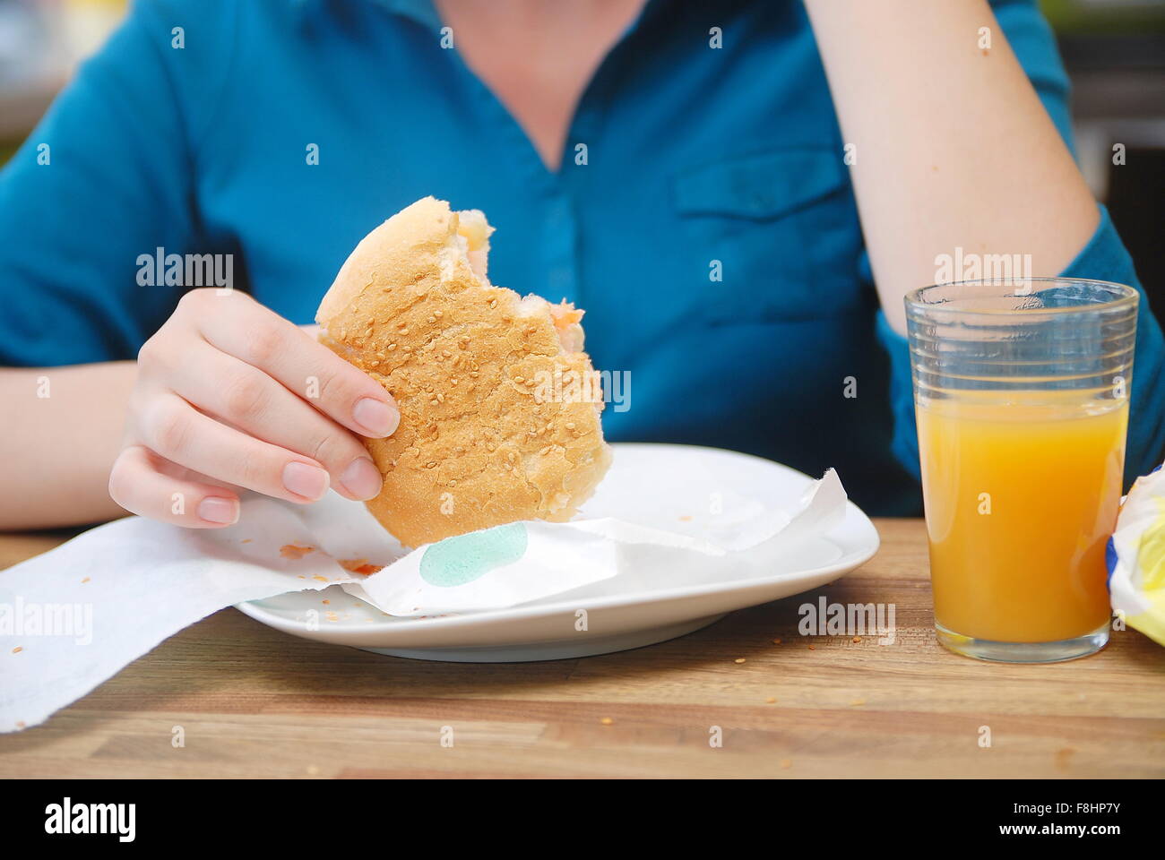 woman eat fast food in restaurant Stock Photo - Alamy