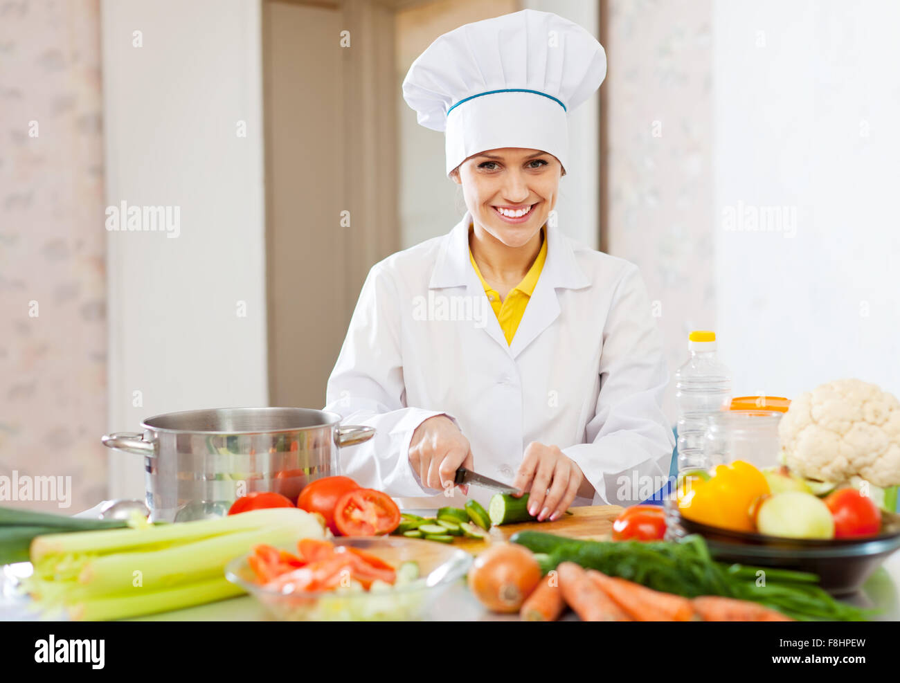 cook in toque prepares veggie lunch at commercial kitchen Stock Photo ...