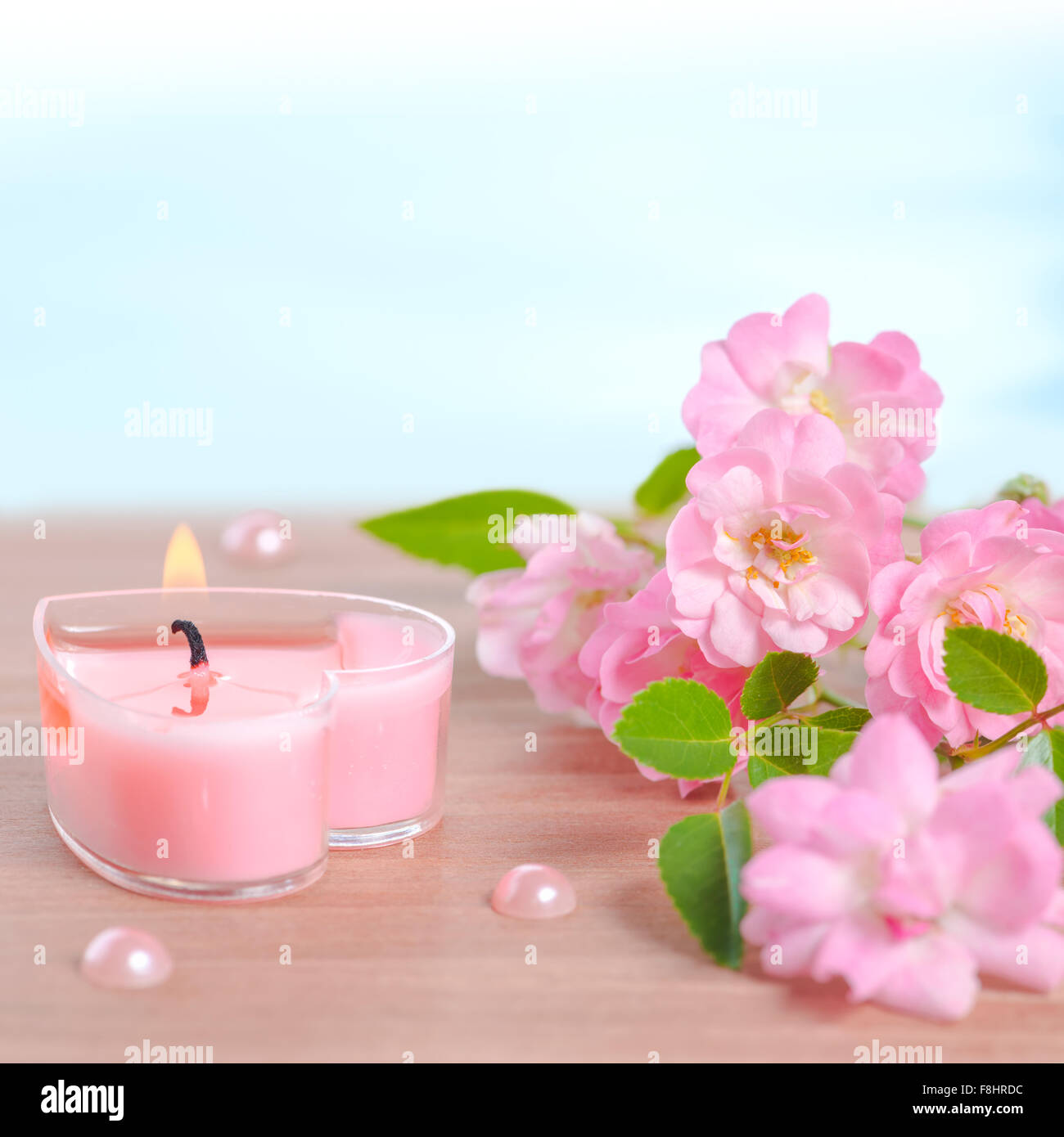 Valentine card of pink heart shaped candle, pearl beads and bouquet ...