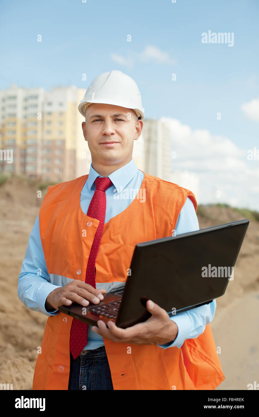 Portrait of builder works at construction site Stock Photo - Alamy