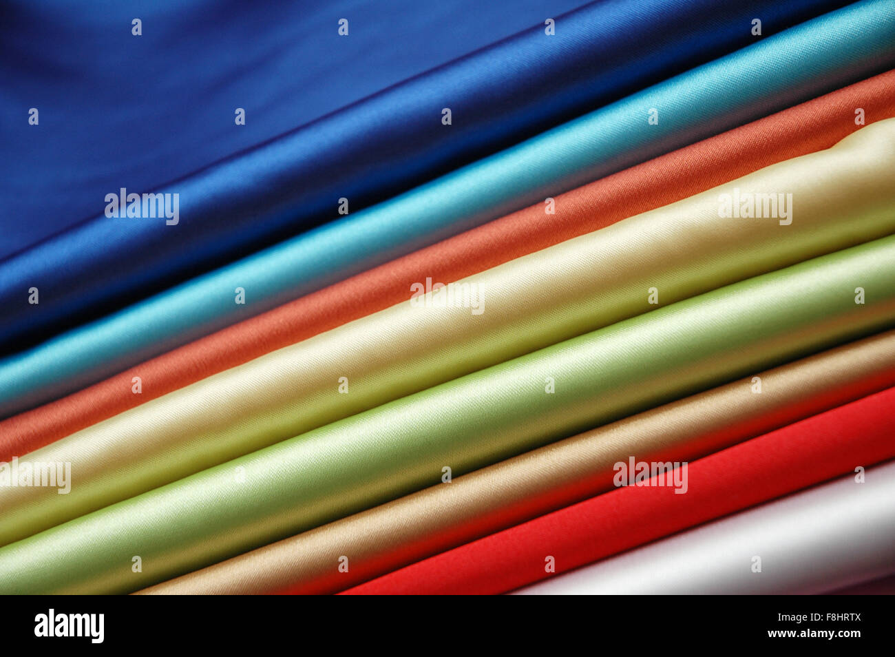 Stack of satin fabric of various colours Stock Photo - Alamy