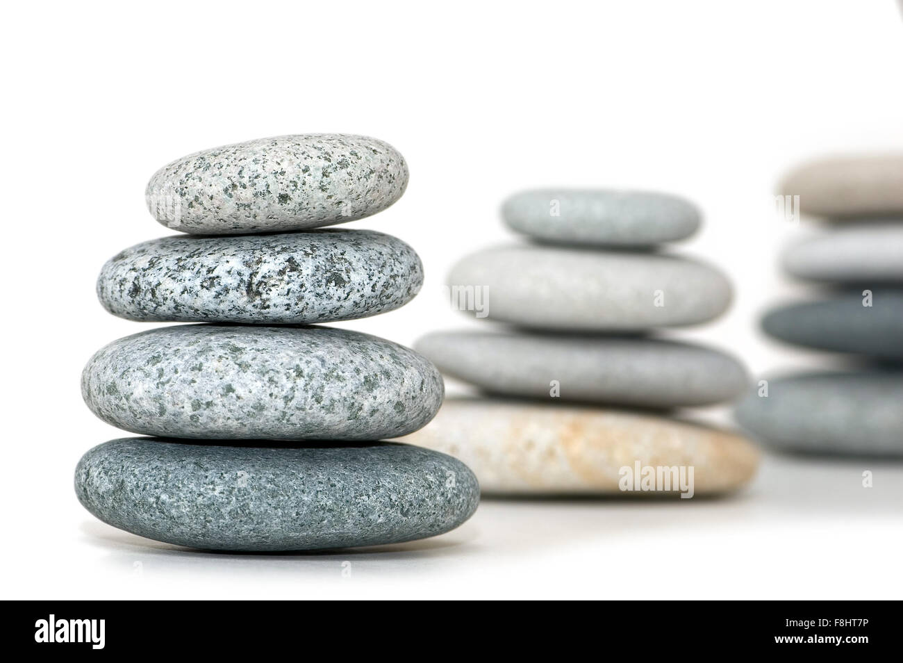 Stack of pebbles isolated on the white Stock Photo - Alamy