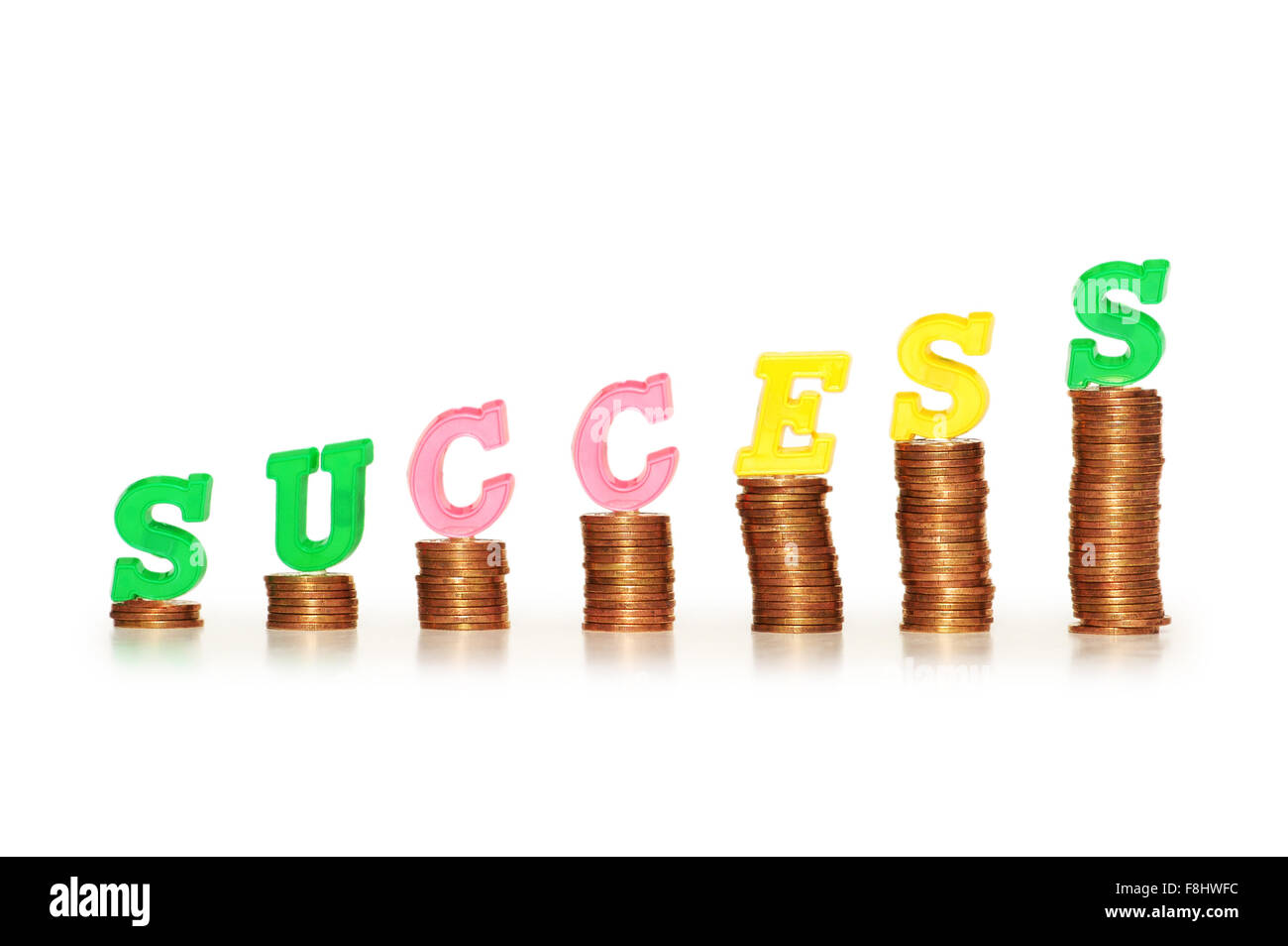 Word "Success" on top of coin stacks Stock Photo - Alamy