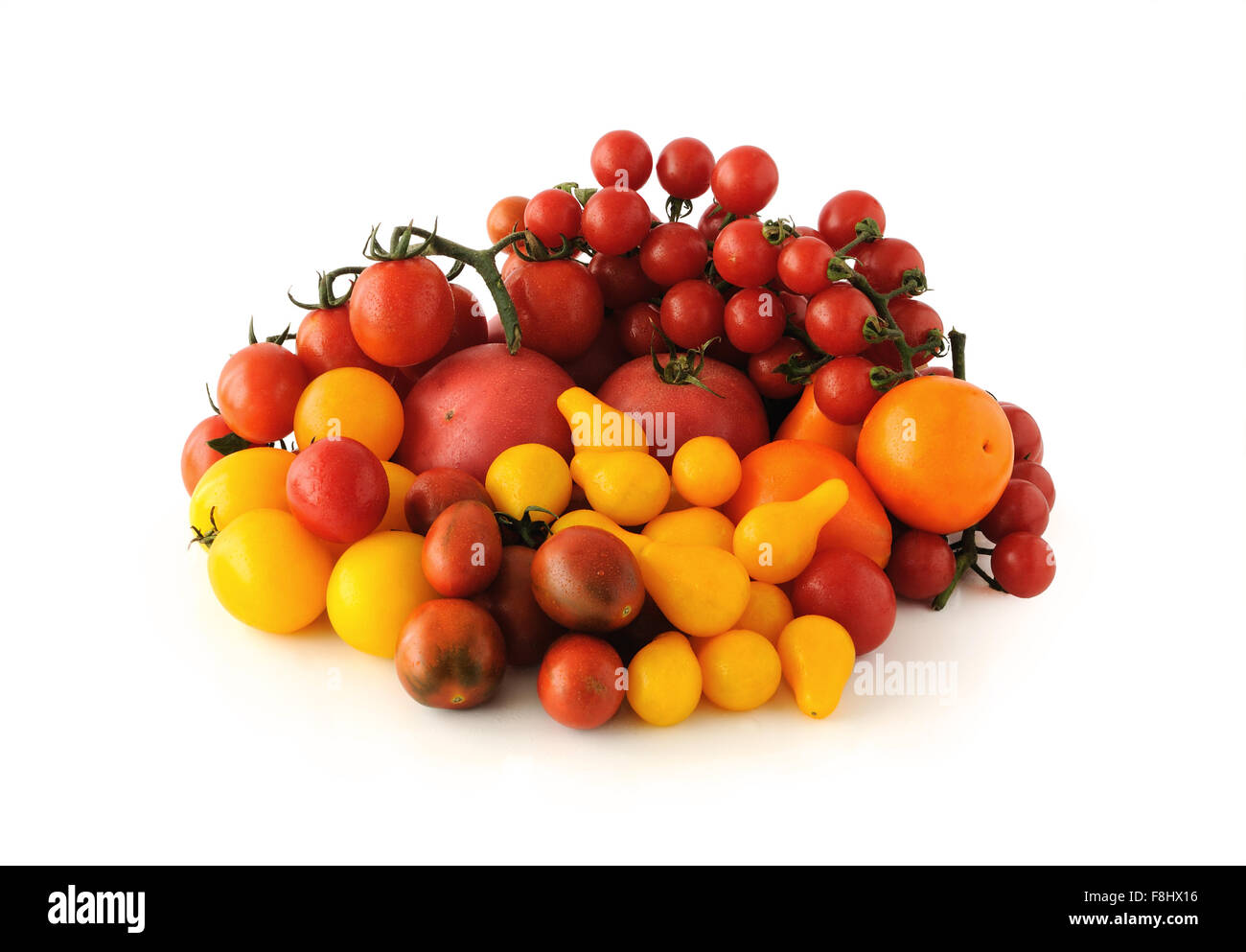 Group of tomatoes of different colors and varieties on a white ...