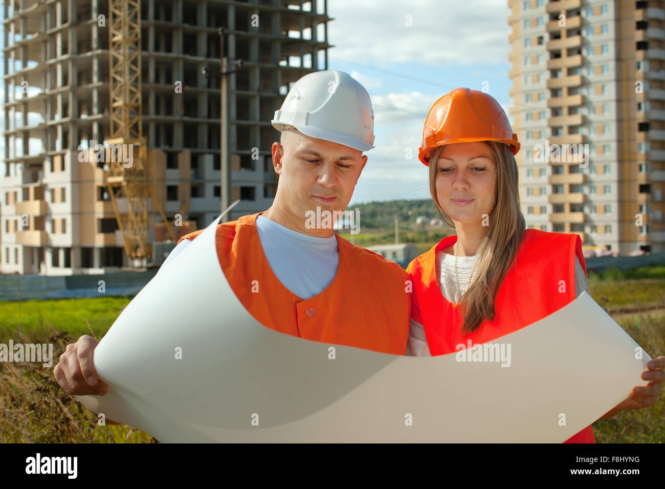 Portrait of two builders works at construction site Stock Photo - Alamy