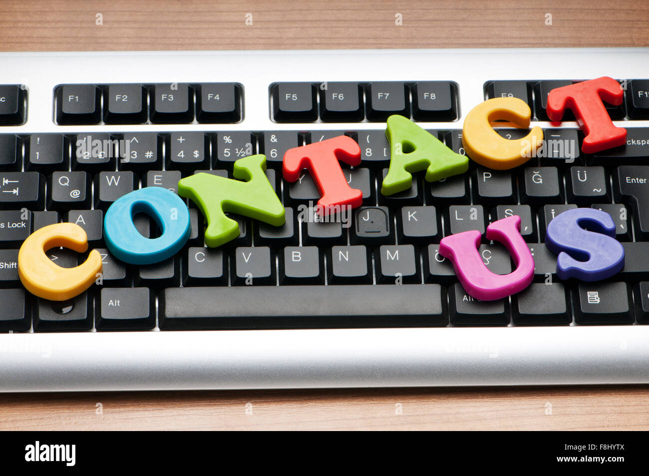 Contact us concept with letters on keyboard Stock Photo - Alamy