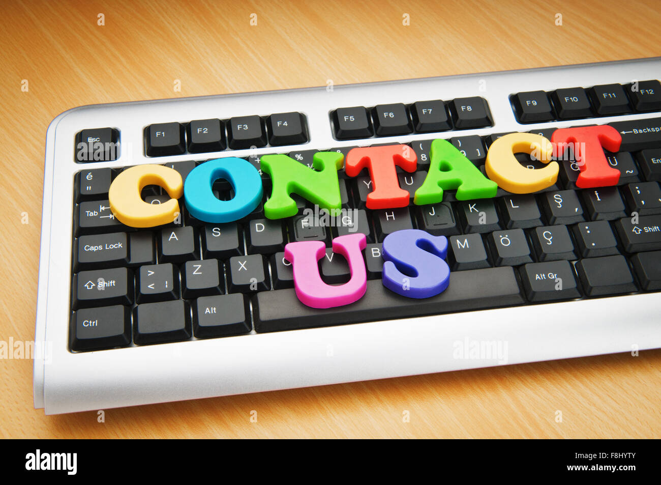 Contact us concept with letters on keyboard Stock Photo - Alamy