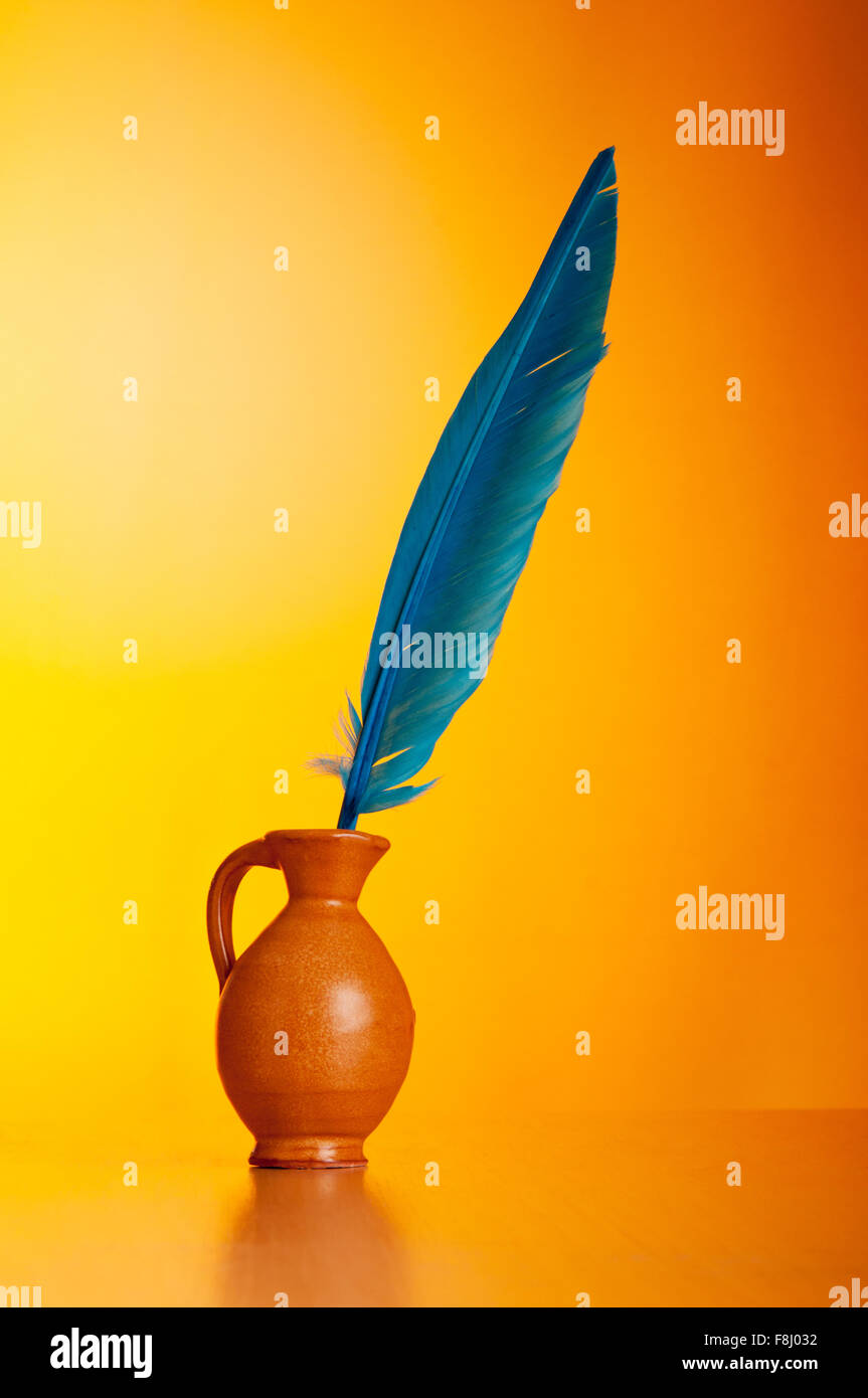 Writing feather against gradient background Stock Photo - Alamy
