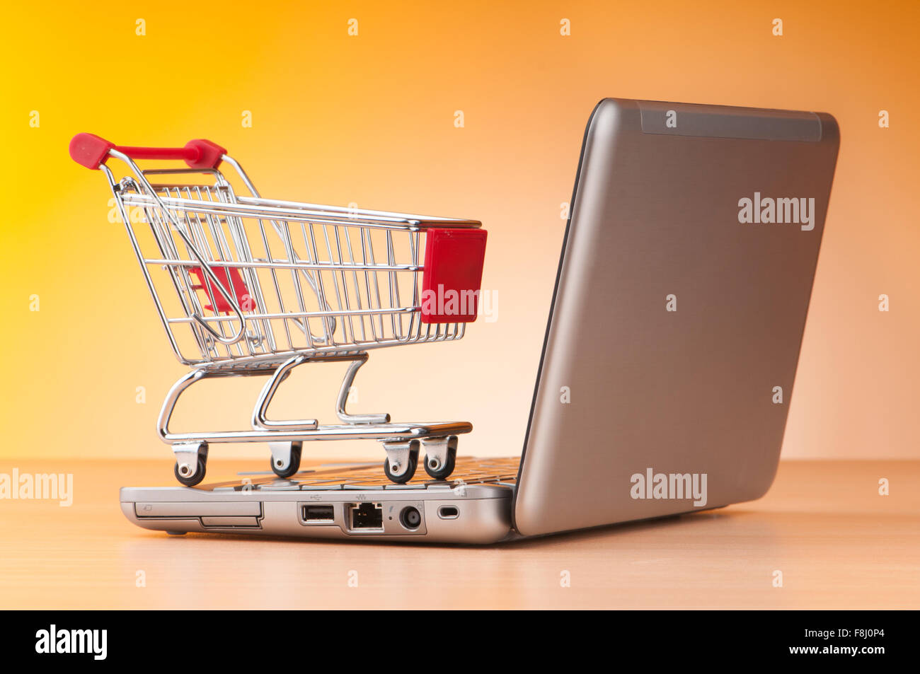 Internet online shopping concept with computer and cart Stock Photo - Alamy