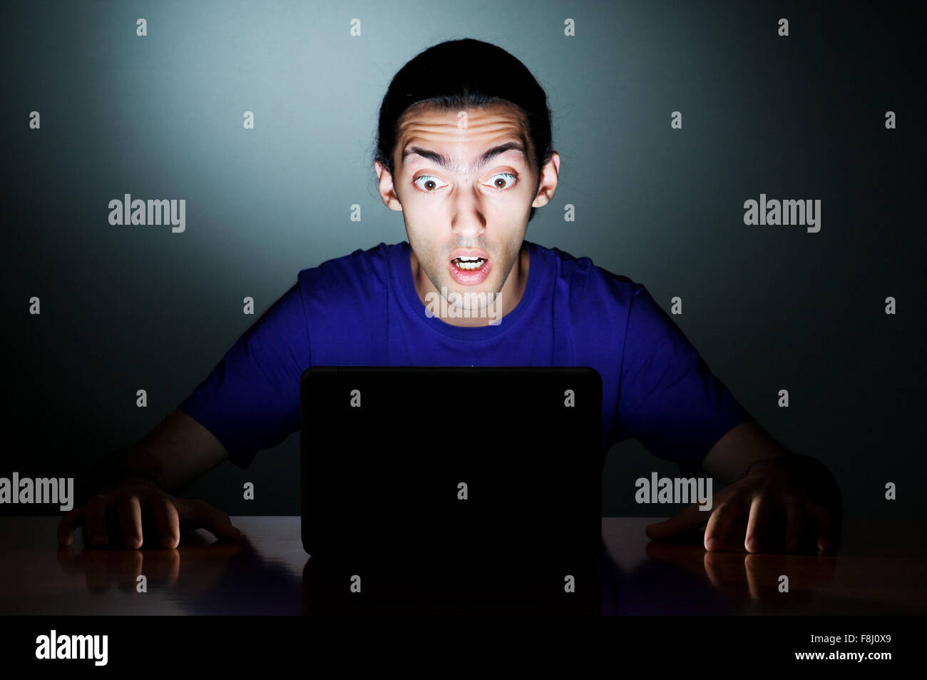 Hacker sitting in dark room Stock Photo - Alamy