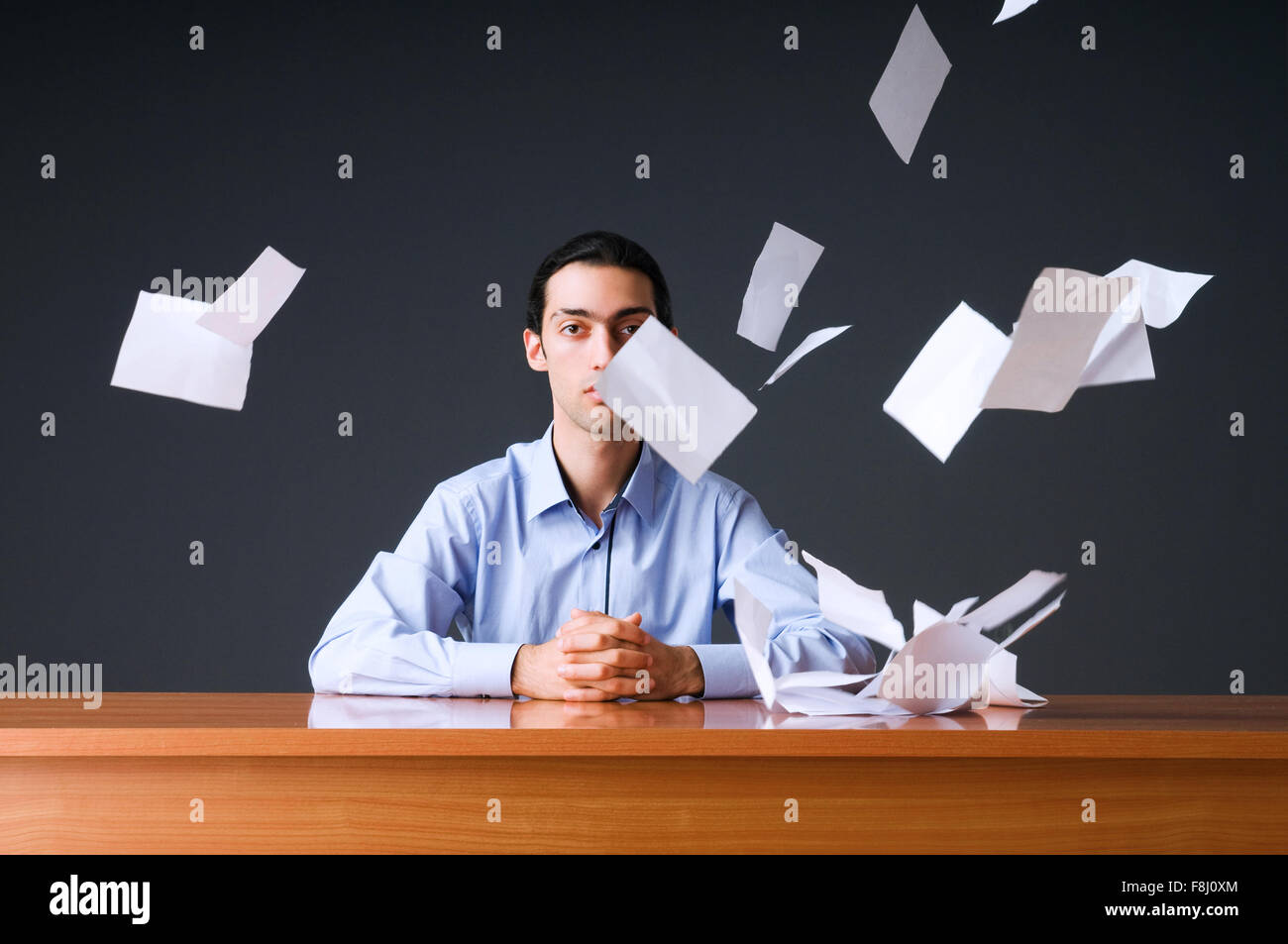 Flying paper and businessman in office Stock Photo - Alamy