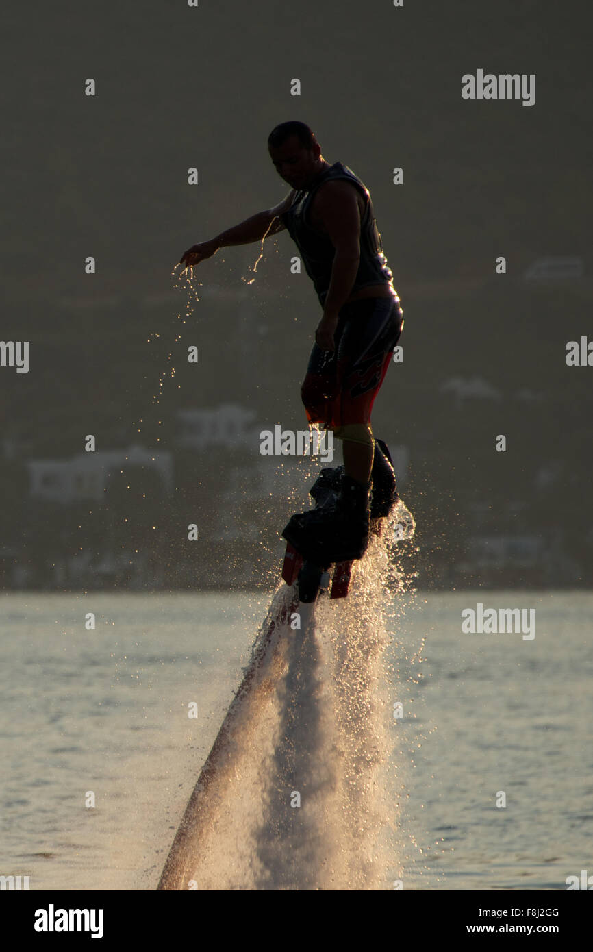 Close-up of silhouetted Flyboarder dripping with water Stock Photo - Alamy