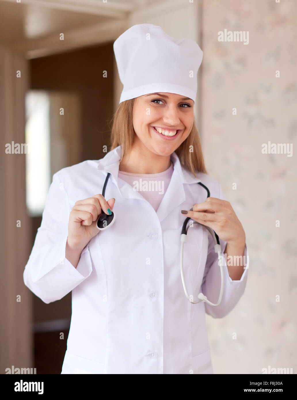 Portrait of friendly doctor in clinic interior Stock Photo - Alamy