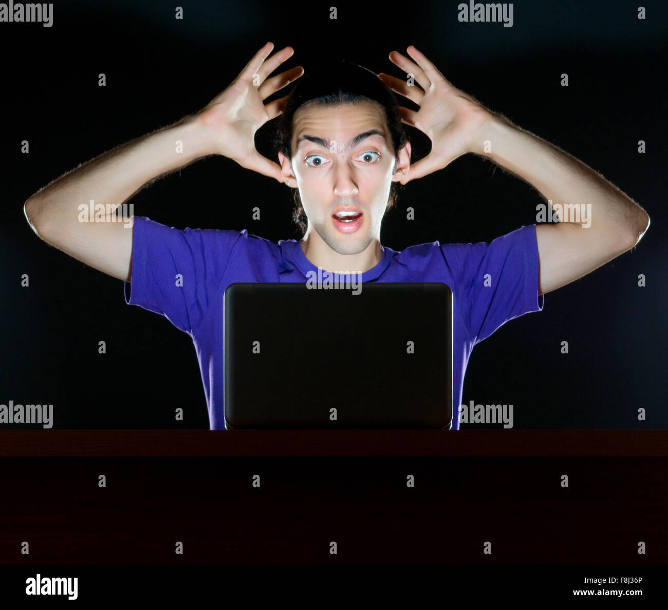 Hacker sitting in dark room Stock Photo - Alamy