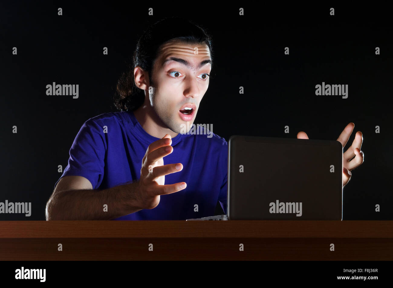 Hacker sitting in dark room Stock Photo - Alamy