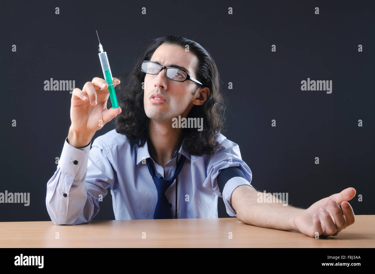 Young druc addict with syringe Stock Photo - Alamy