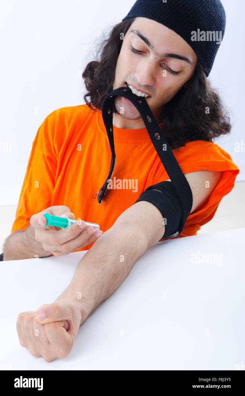 Young druc addict with syringe Stock Photo - Alamy