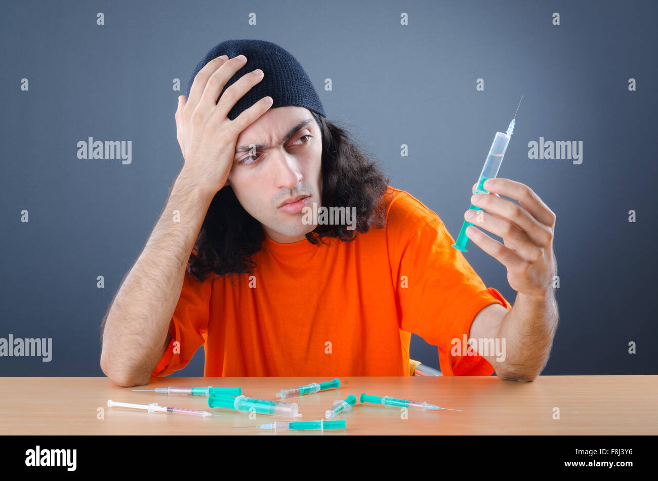 Young druc addict with syringe Stock Photo - Alamy