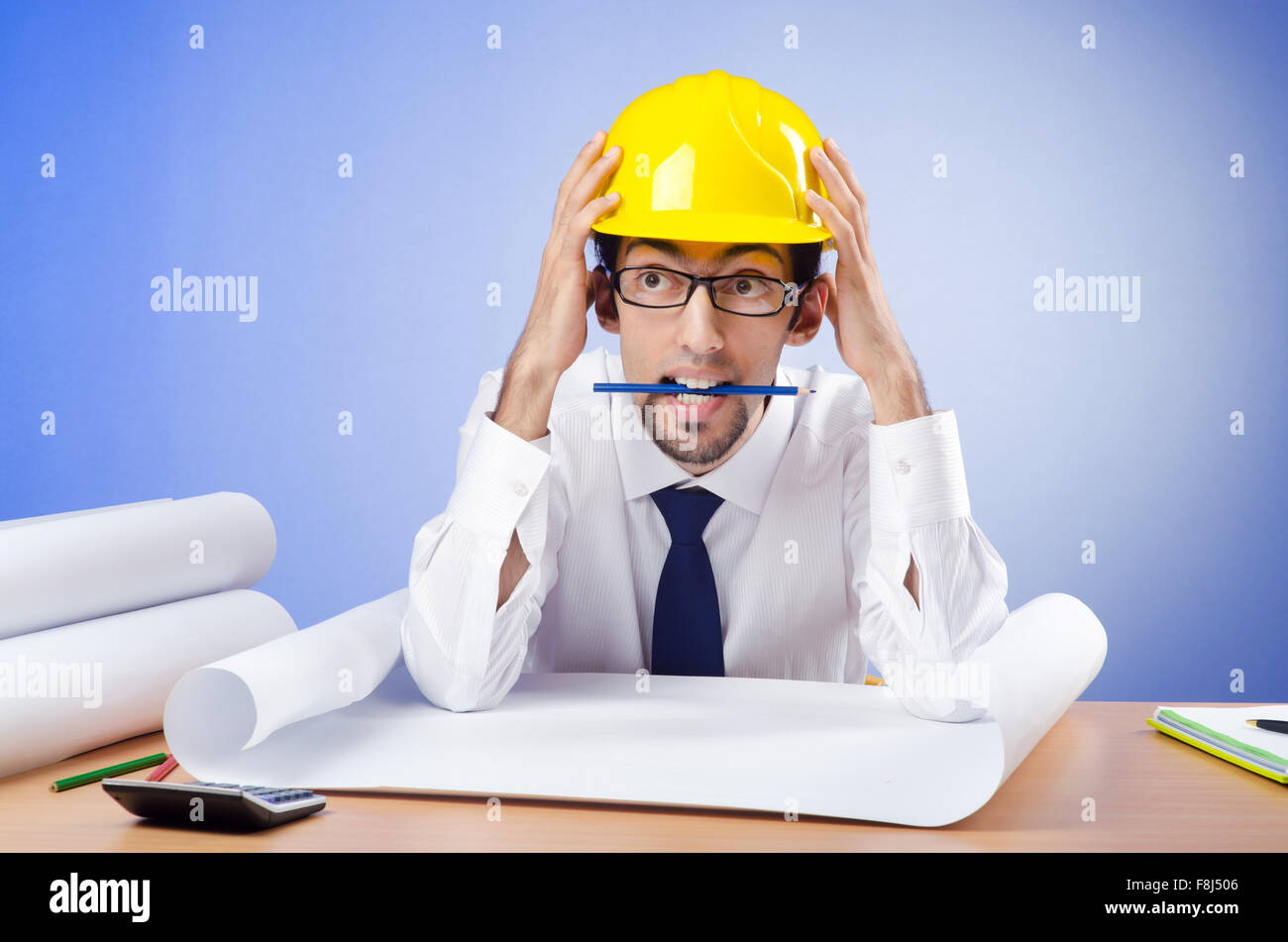 Young engineer looking at drawings Stock Photo - Alamy