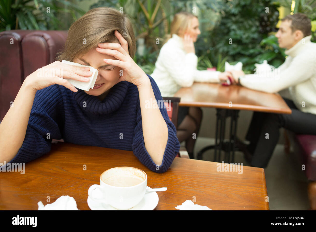girl crying on background happy couple. sitting in cafe Stock Photo - Alamy