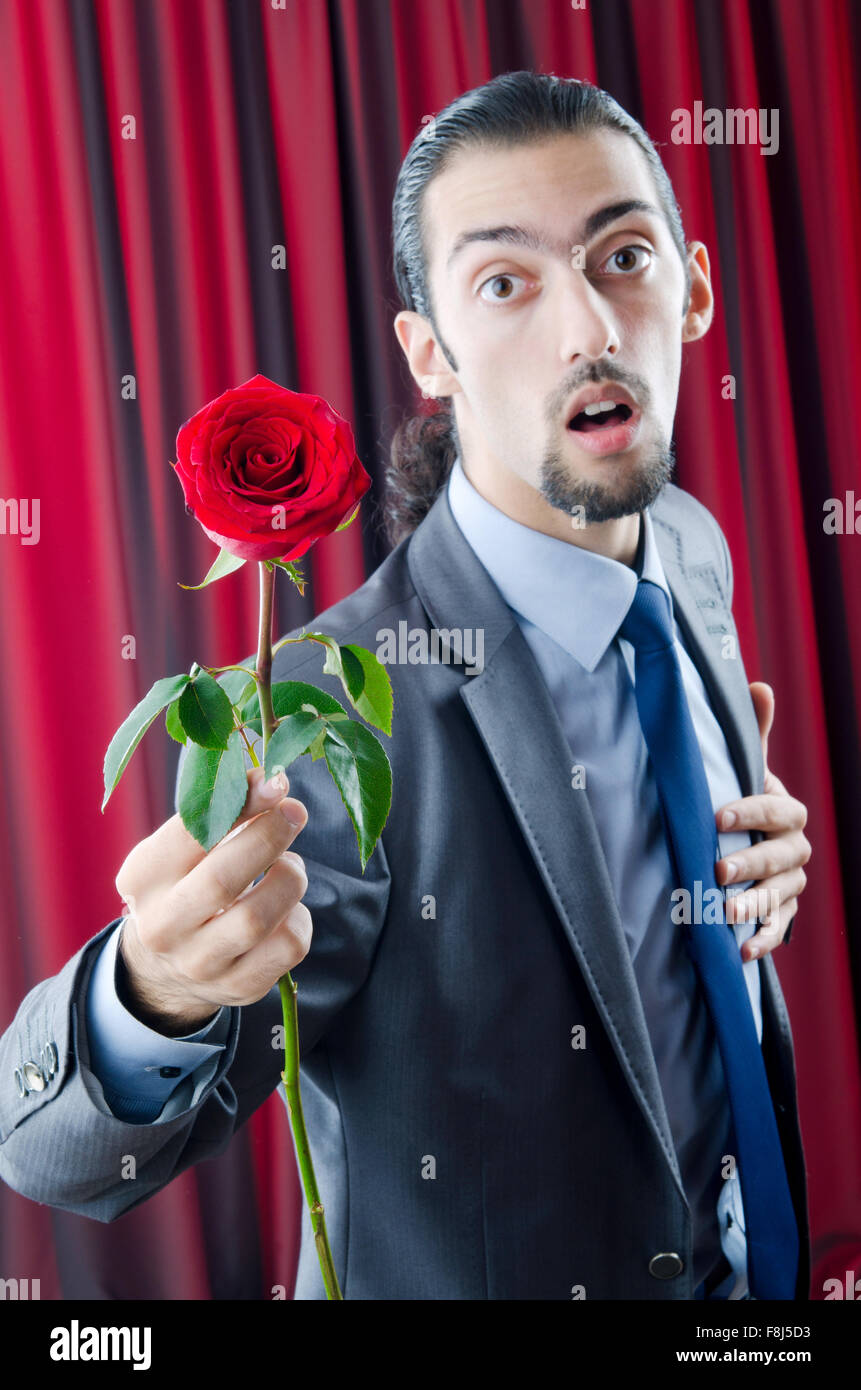 Young man with red rose Stock Photo - Alamy