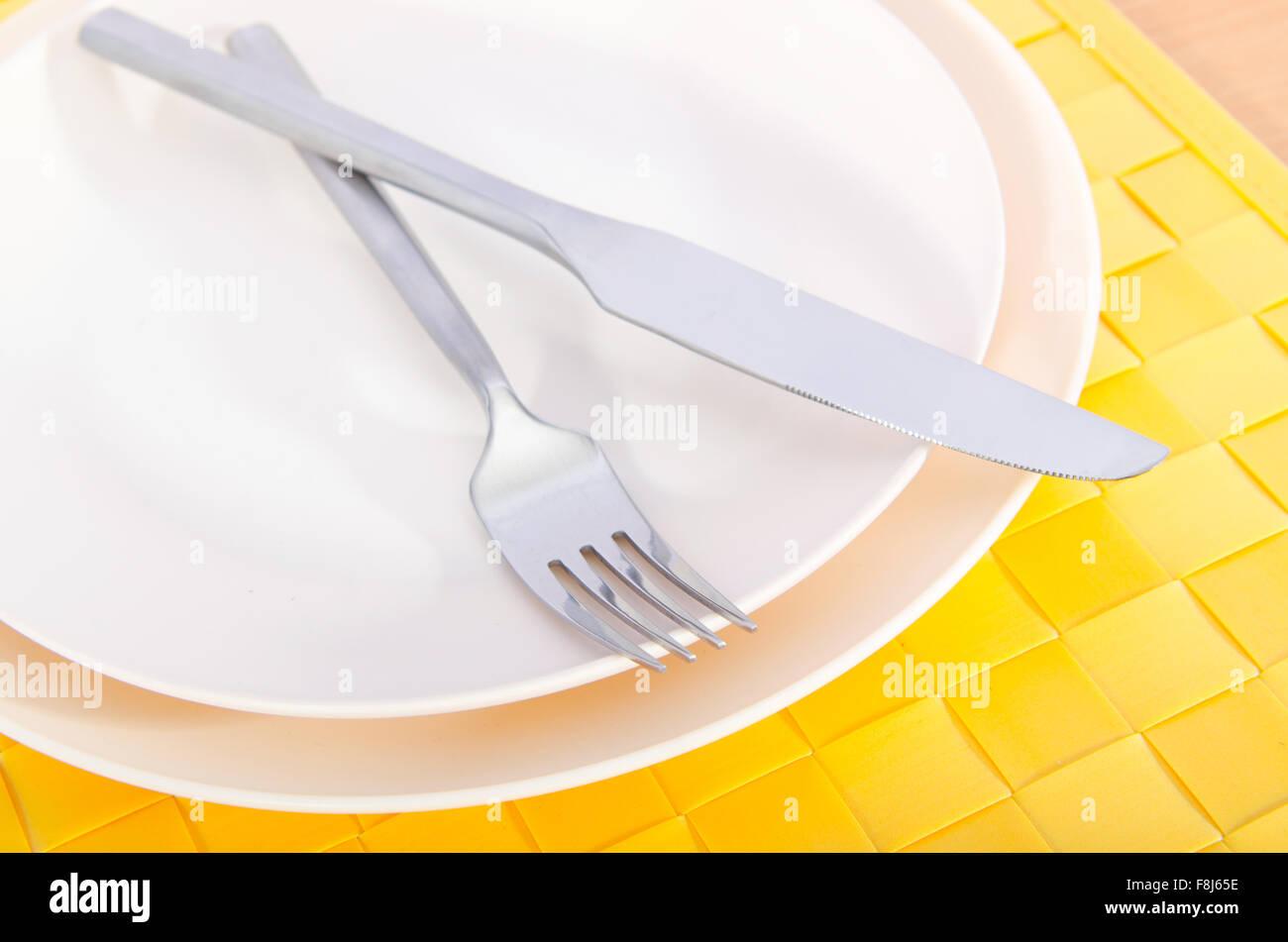 Empty plate with utensils Stock Photo - Alamy