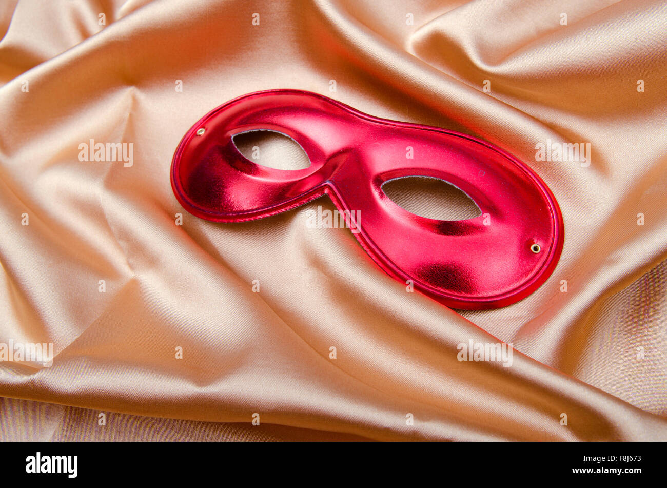 Carnical mask on satin background Stock Photo - Alamy