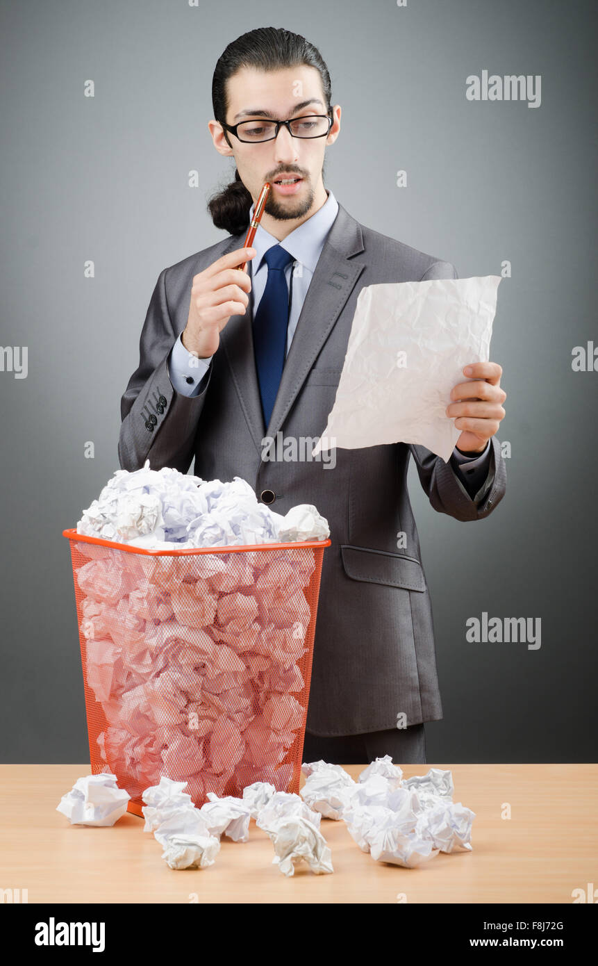 Man with lots of wasted paper Stock Photo - Alamy