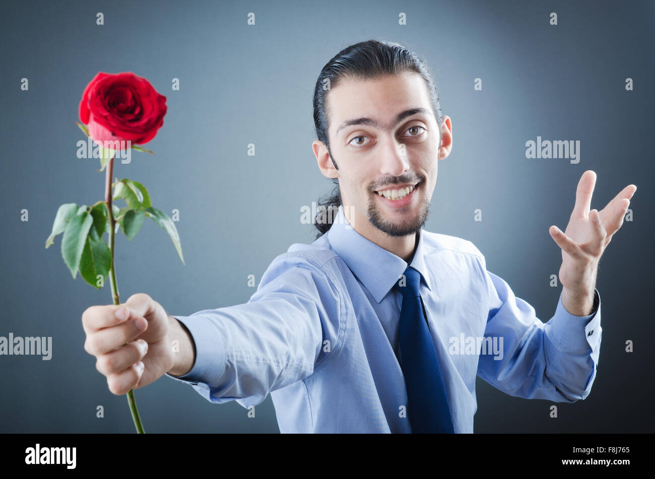Young man with red rose Stock Photo - Alamy
