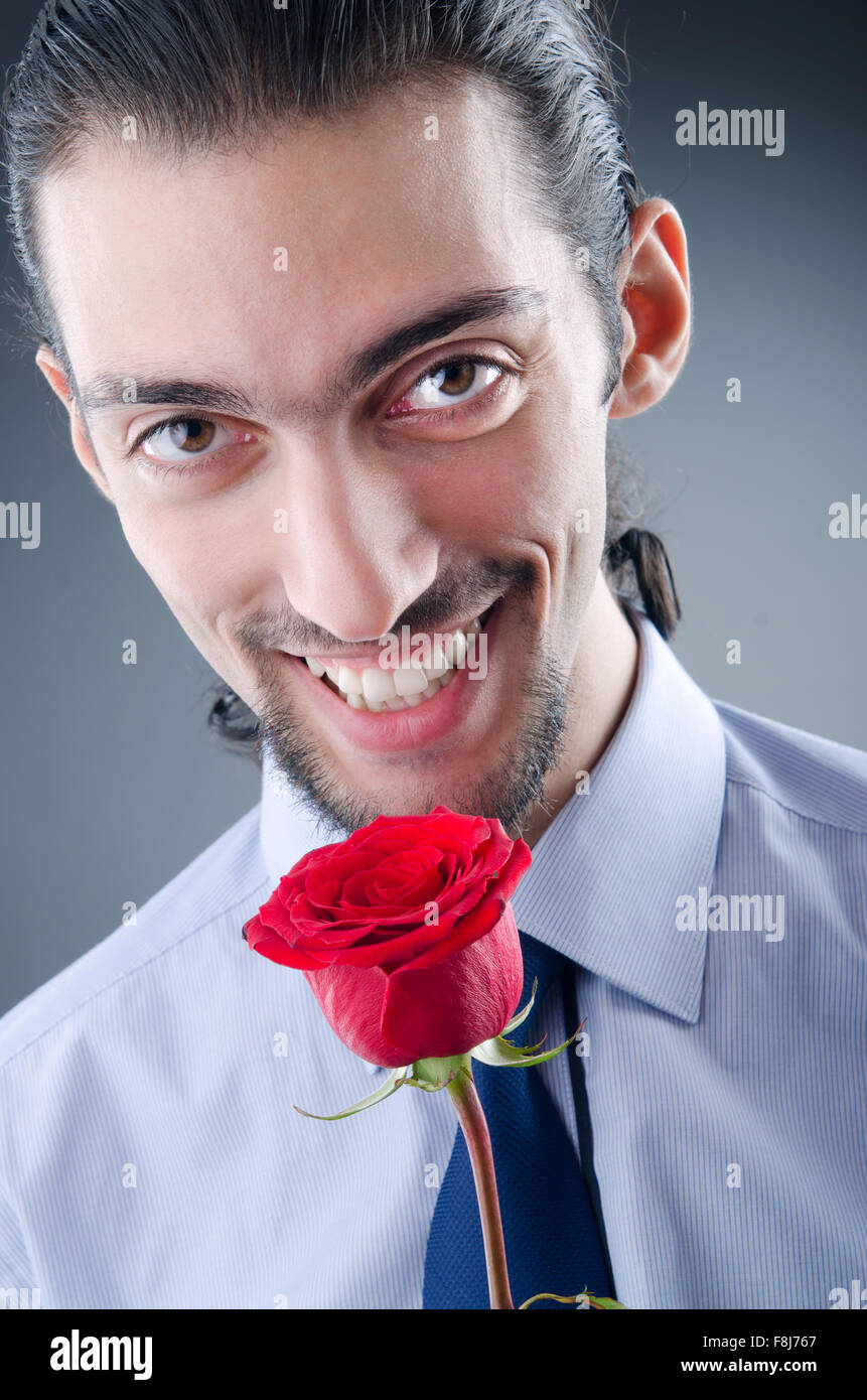 Young man with red rose Stock Photo - Alamy