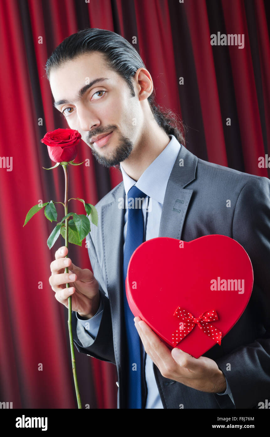 Young man with red rose Stock Photo - Alamy