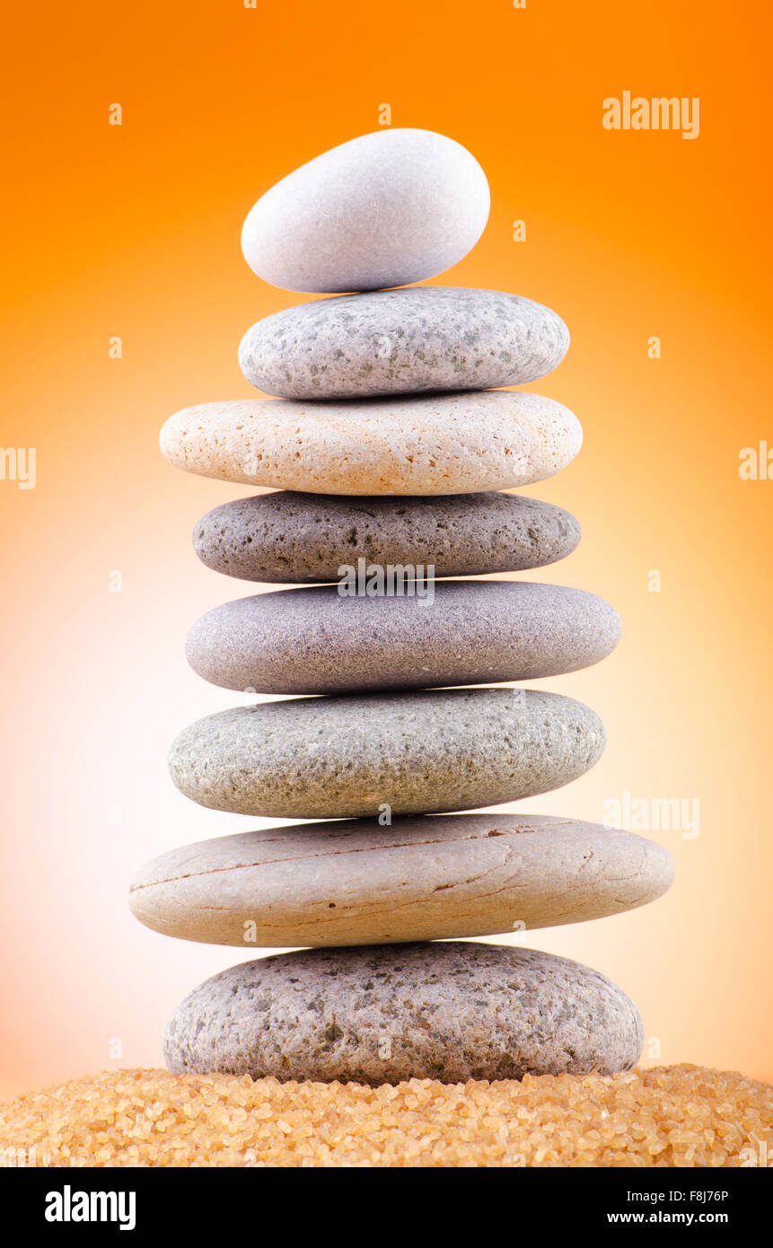 Balanced pebbles with colour background Stock Photo - Alamy