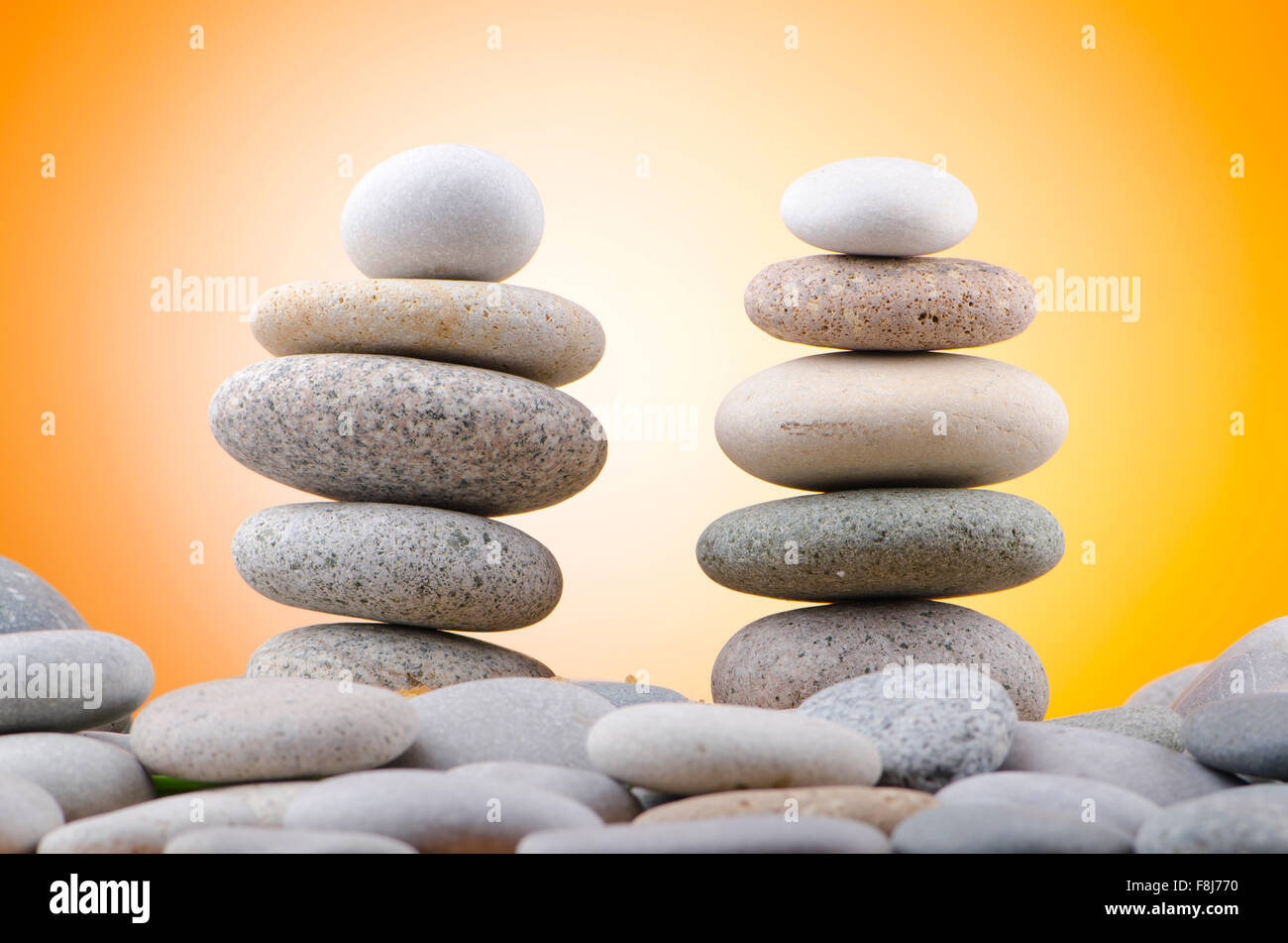 Balanced pebbles with colour background Stock Photo - Alamy
