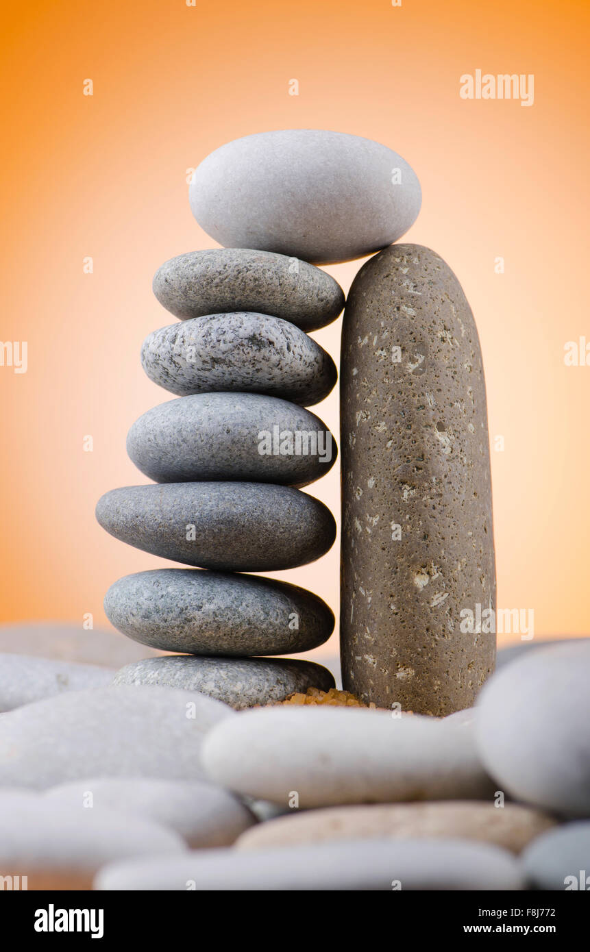 Balanced pebbles with colour background Stock Photo - Alamy