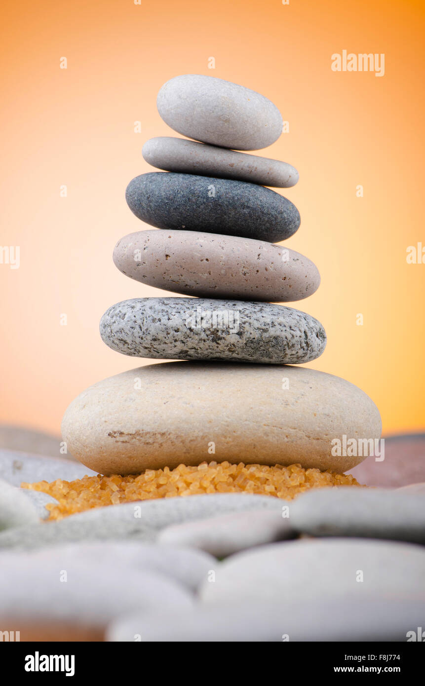 Balanced pebbles with colour background Stock Photo - Alamy
