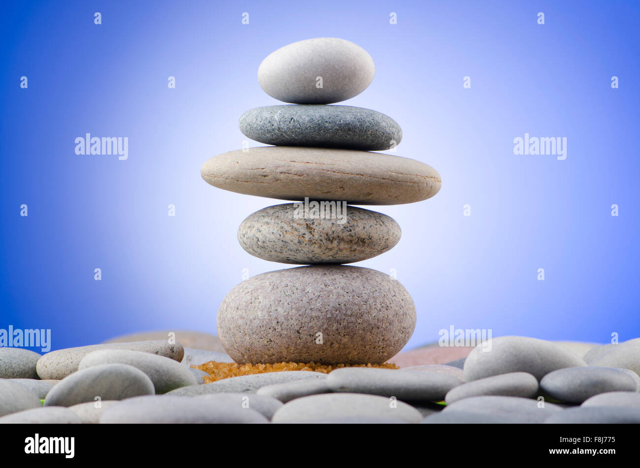 Balanced pebbles with colour background Stock Photo - Alamy