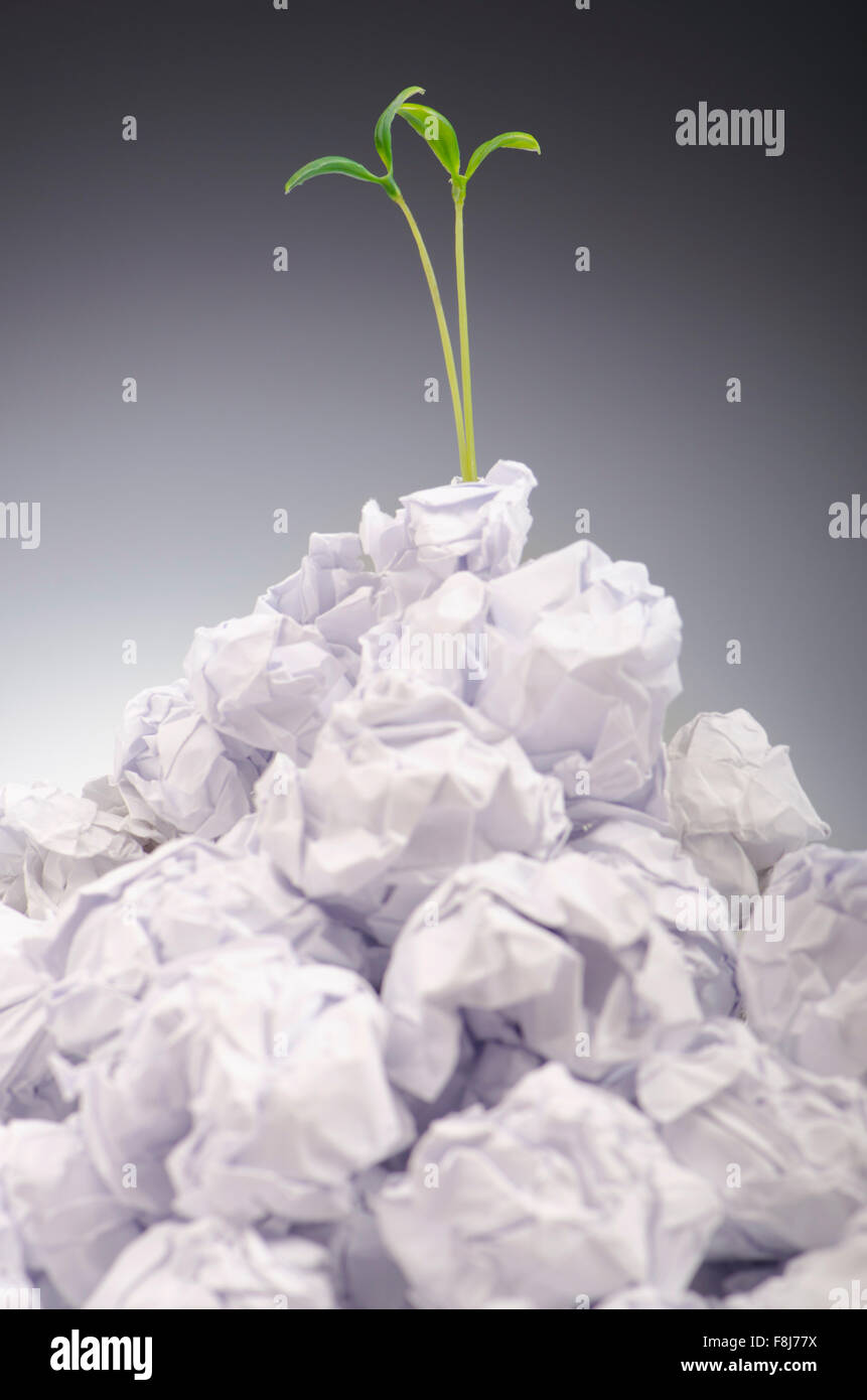 Green seedlings growing out of paper Stock Photo - Alamy