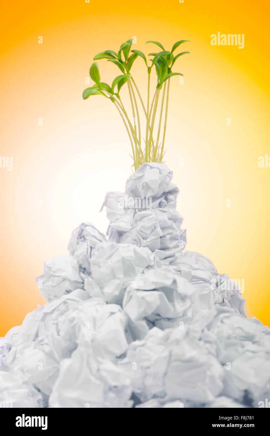 Green seedlings growing out of paper Stock Photo - Alamy