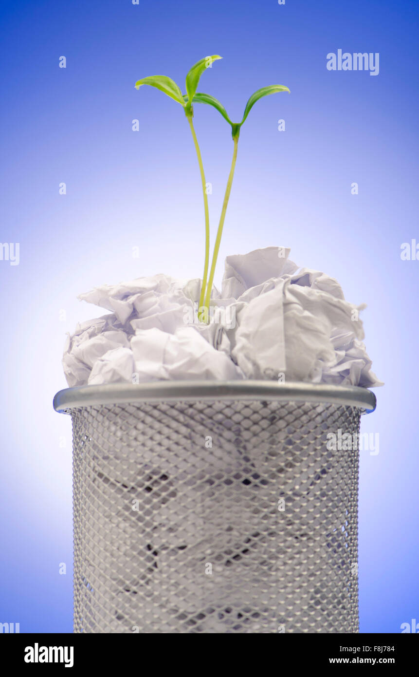 Green seedlings growing out of paper Stock Photo - Alamy