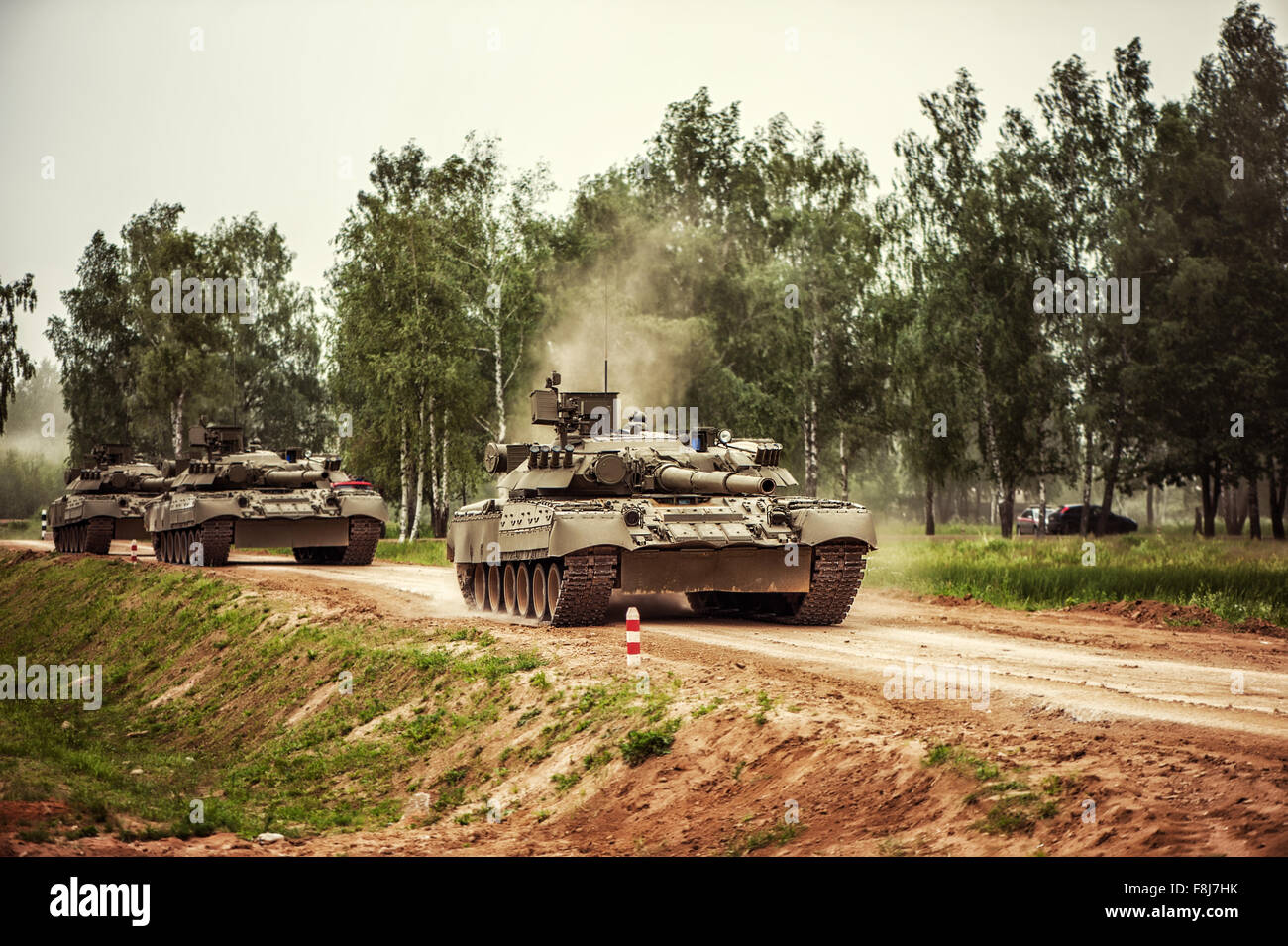 Three russian tanks driving on a country road, dust clouds around Stock ...