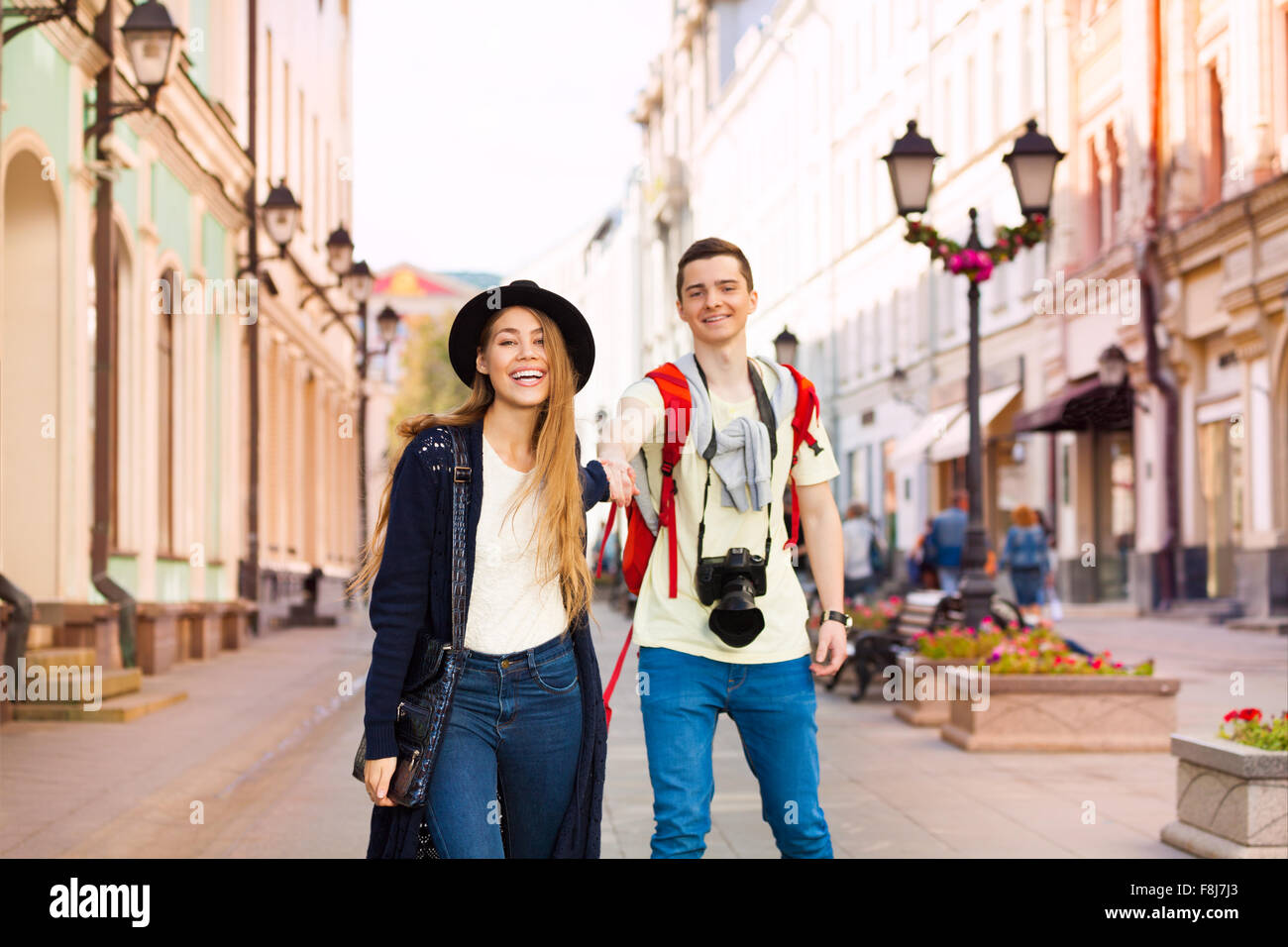 Happy girl holds hand of young man walking forward Stock Photo - Alamy