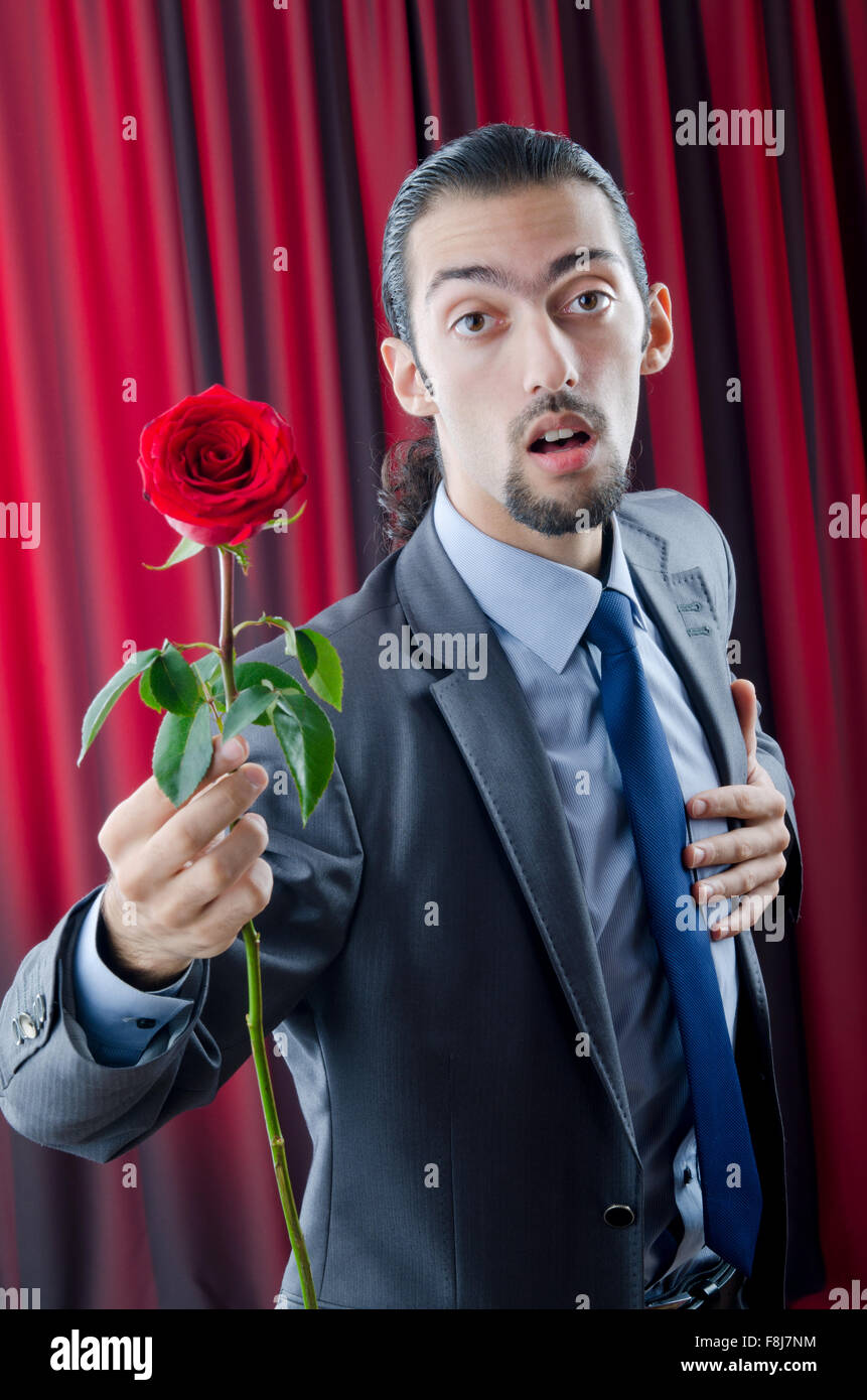 Young man with red rose Stock Photo - Alamy