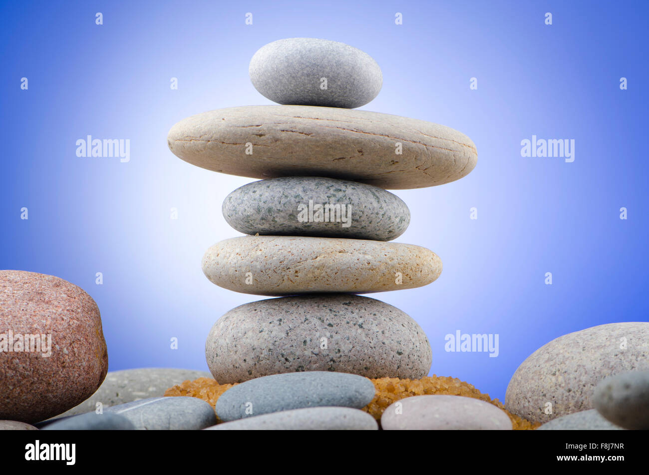 Balanced pebbles with colour background Stock Photo - Alamy