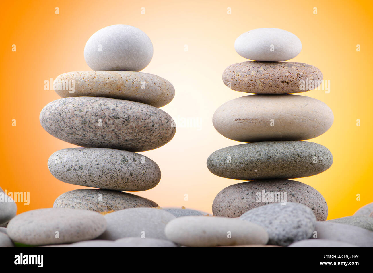 Balanced pebbles with colour background Stock Photo - Alamy