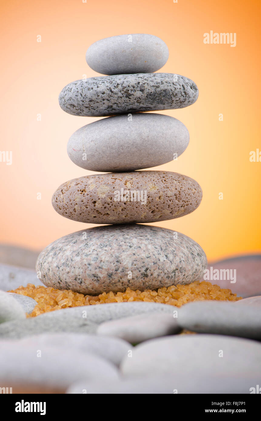 Balanced pebbles with colour background Stock Photo - Alamy