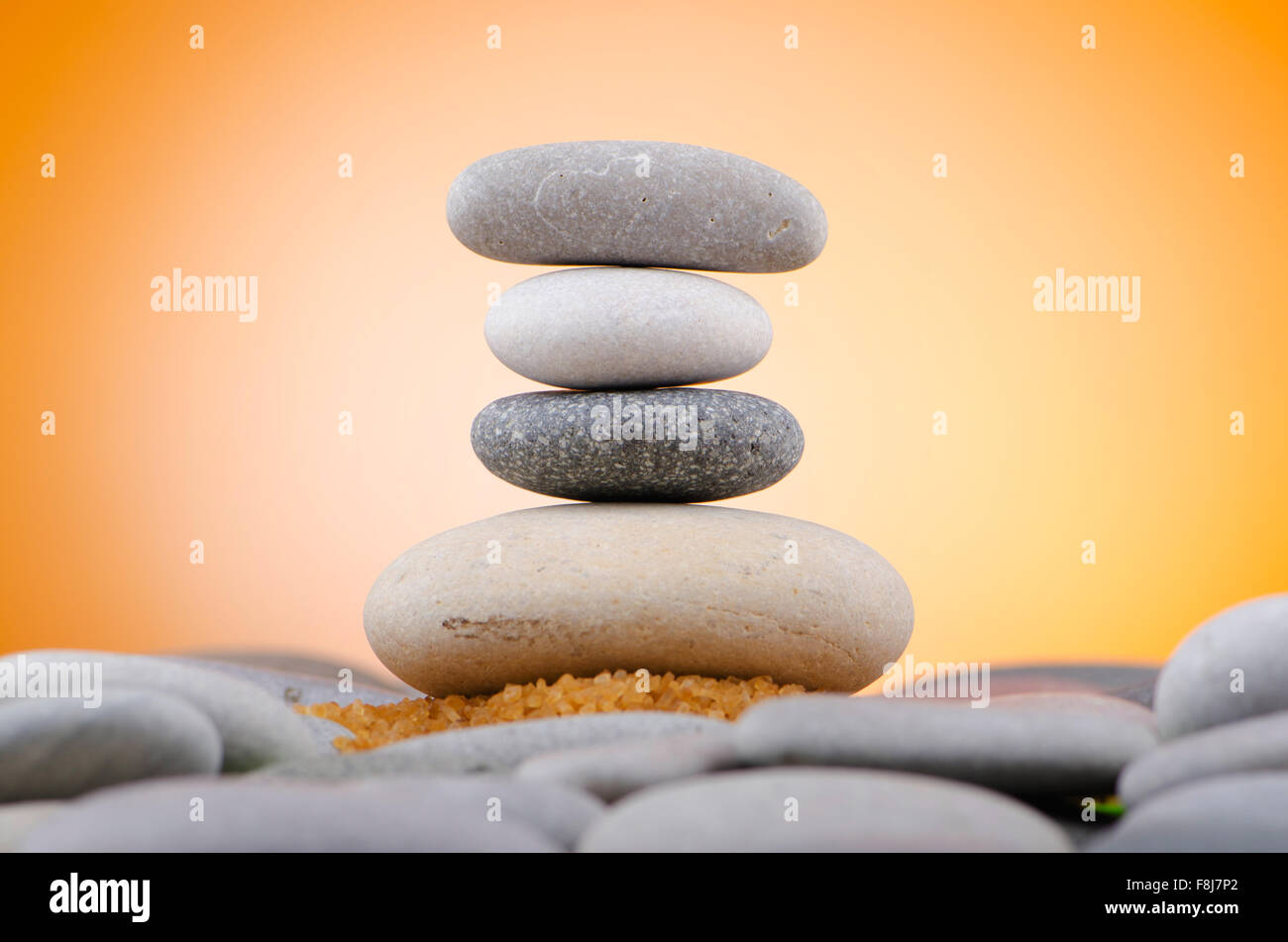 Balanced pebbles with colour background Stock Photo - Alamy